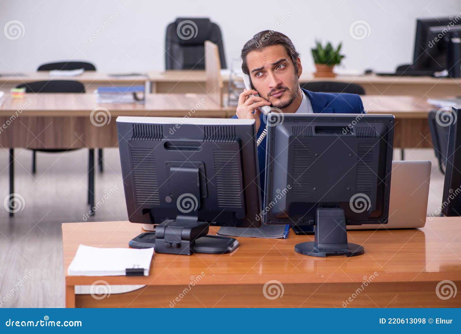 Young Male Employee in Multitasking Concept Stock Photo - Image of ...