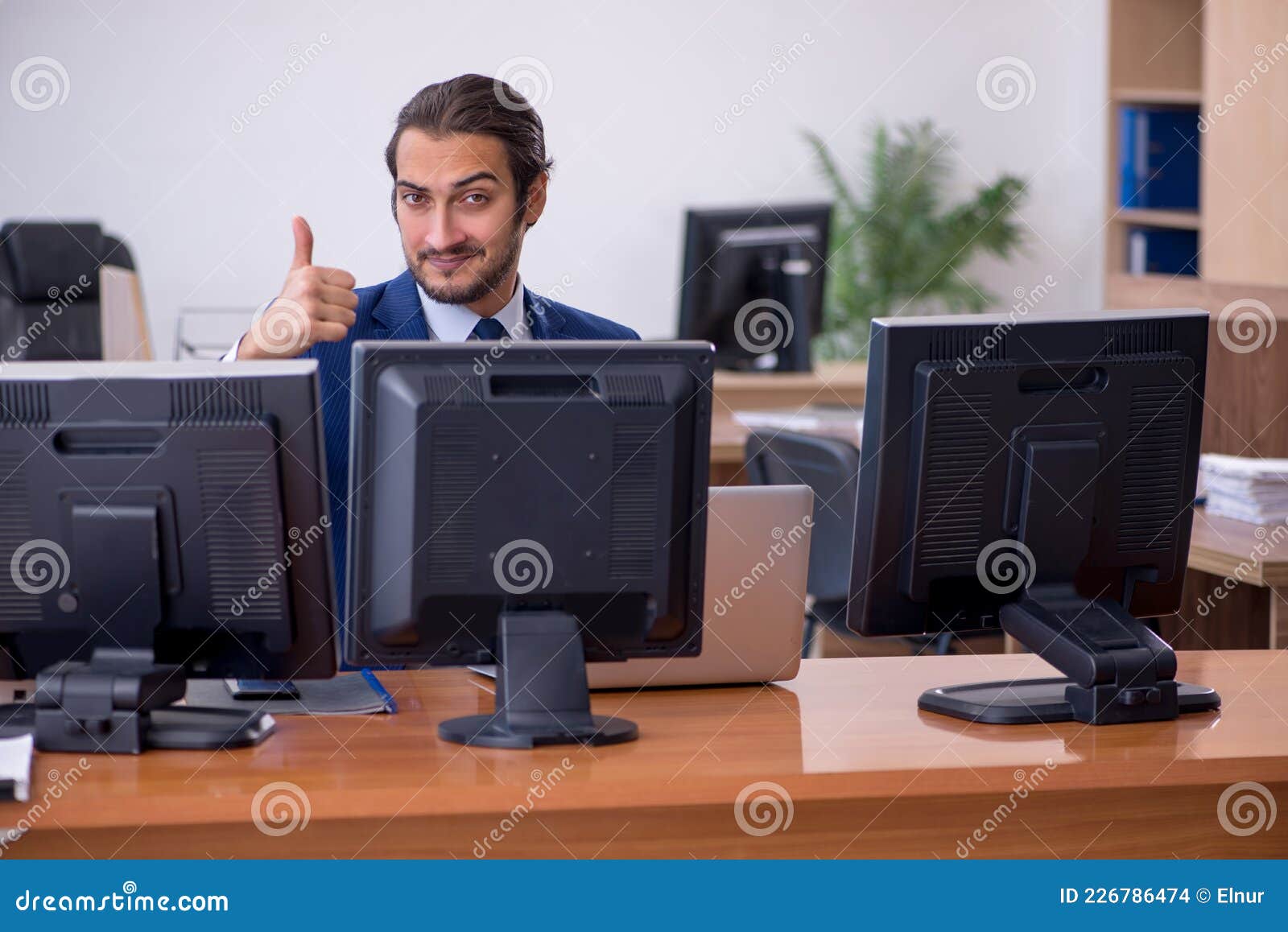 Young Male Employee in Multitasking Concept Stock Photo - Image of ...