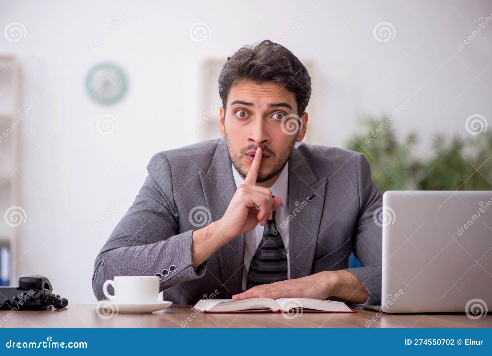Young Male Employee Reading Book in the Office Stock Photo - Image of ...