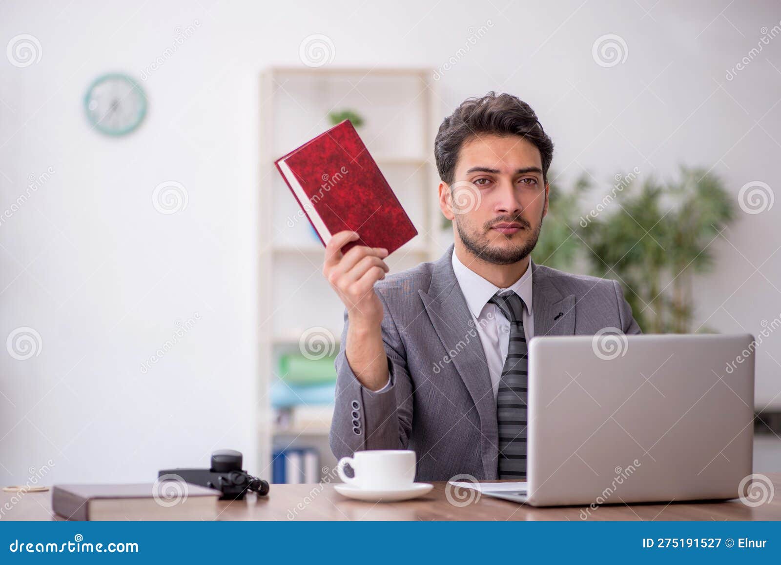 Young Male Employee Reading Book in the Office Stock Image - Image of ...