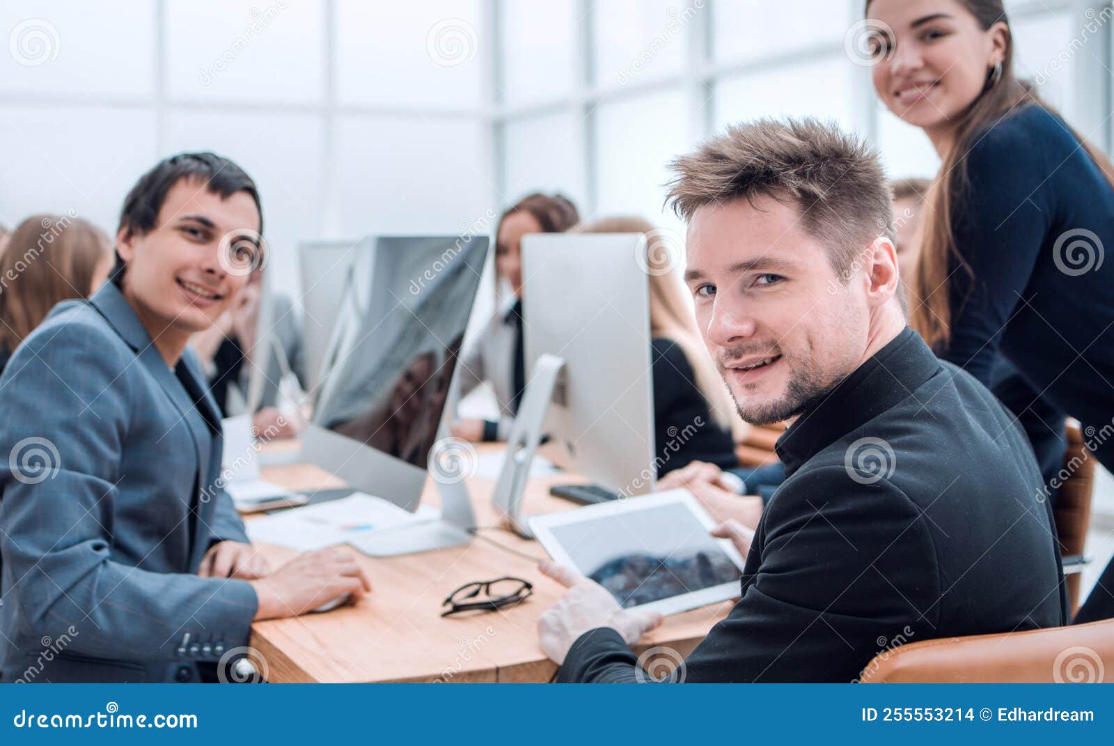 Young Employee Sitting at a Desk about Looking at the Camera. Stock ...