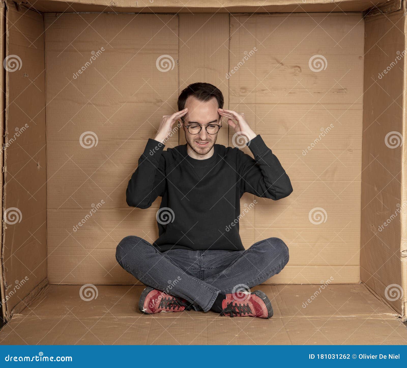 Young Employee Sitting in a Small Cramped Office, Getting Ready To Work ...