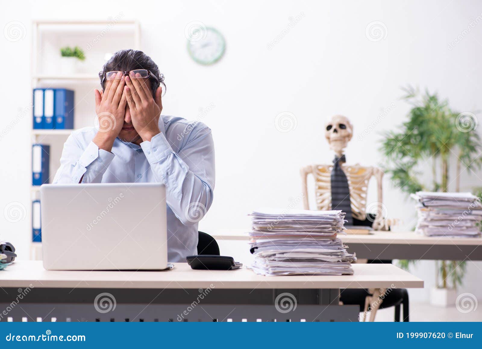 Young Male Employee and Skeleton in the Office Stock Photo - Image of ...