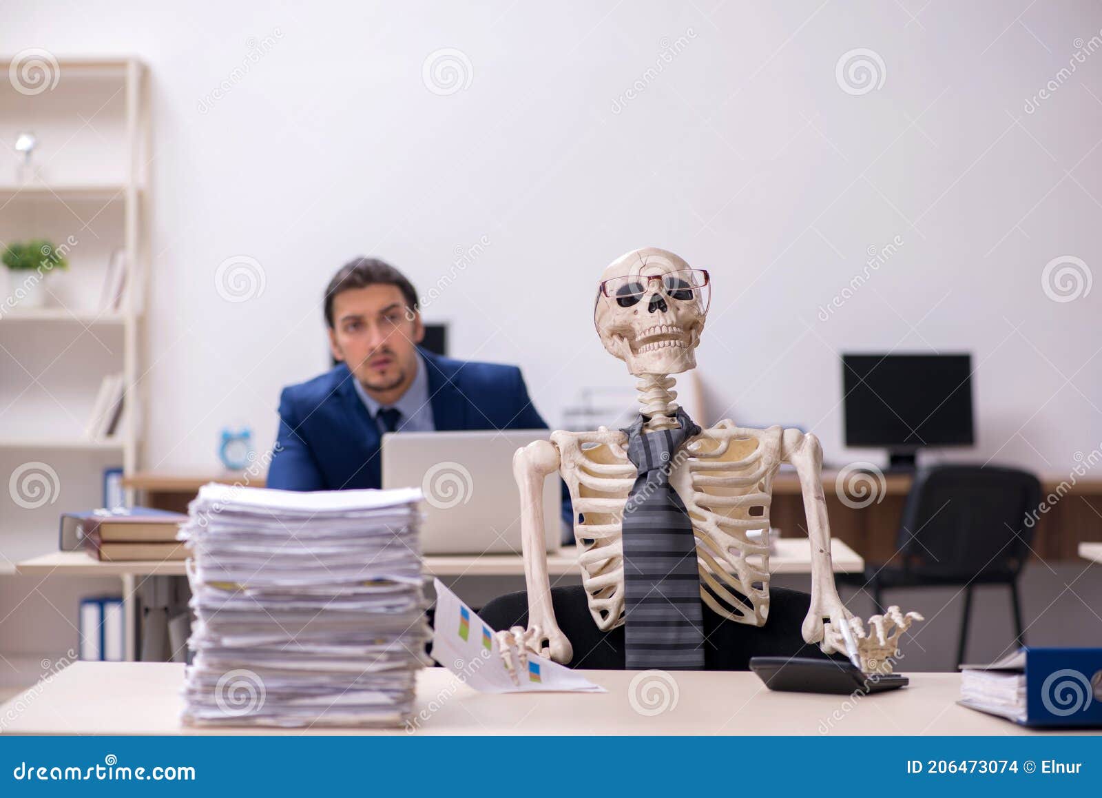 Young Male Employee with Skeletons in the Office Stock Photo - Image of ...