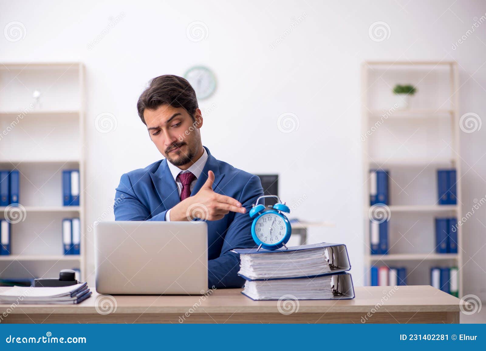 Young Male Employee in Time Management Concept Stock Image - Image of ... Young Male Employee in Time Management Concept Stock Image - Image of ...