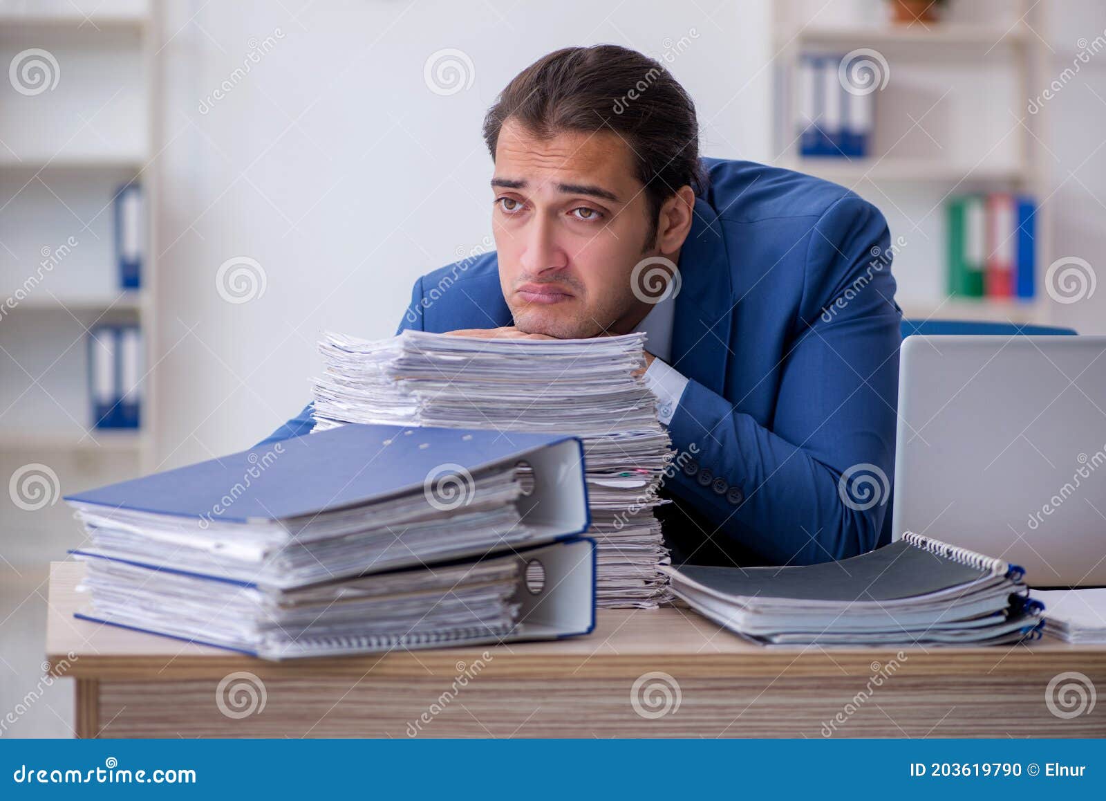 Young Male Employee Unhappy with Excessive Work in the Office Stock ... Young Male Employee Unhappy with Excessive Work in the Office Stock ...