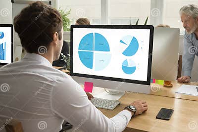Young Employee Using Computer Analyzing Data, Statistics Analysi Stock ...