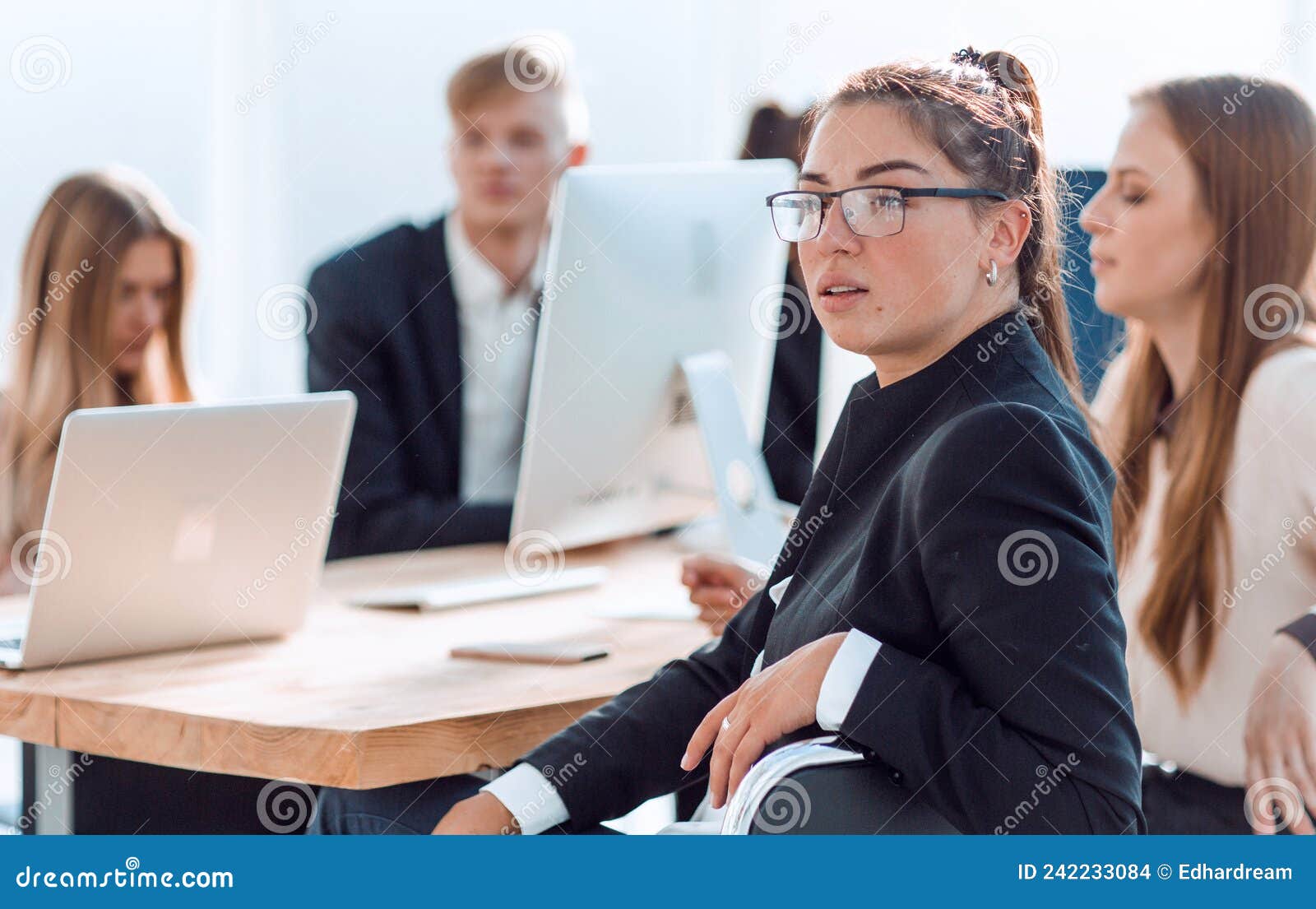 Young Employees Discussing Something at the Desk Stock Photo - Image of ...