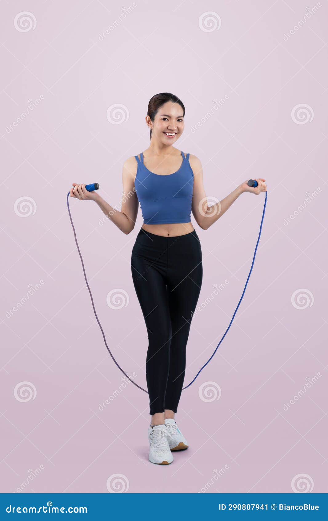 Young Energetic Asian Woman In Sportswear With Jumping Rope Vigorous
