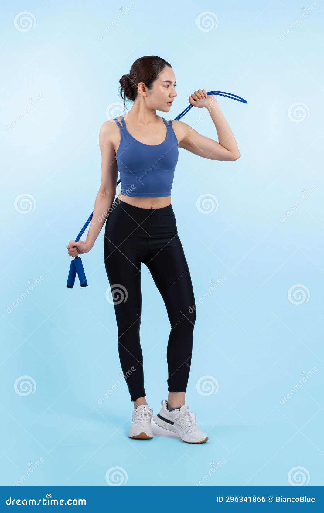 Young Energetic Asian Woman In Sportswear With Jumping Rope Vigorous
