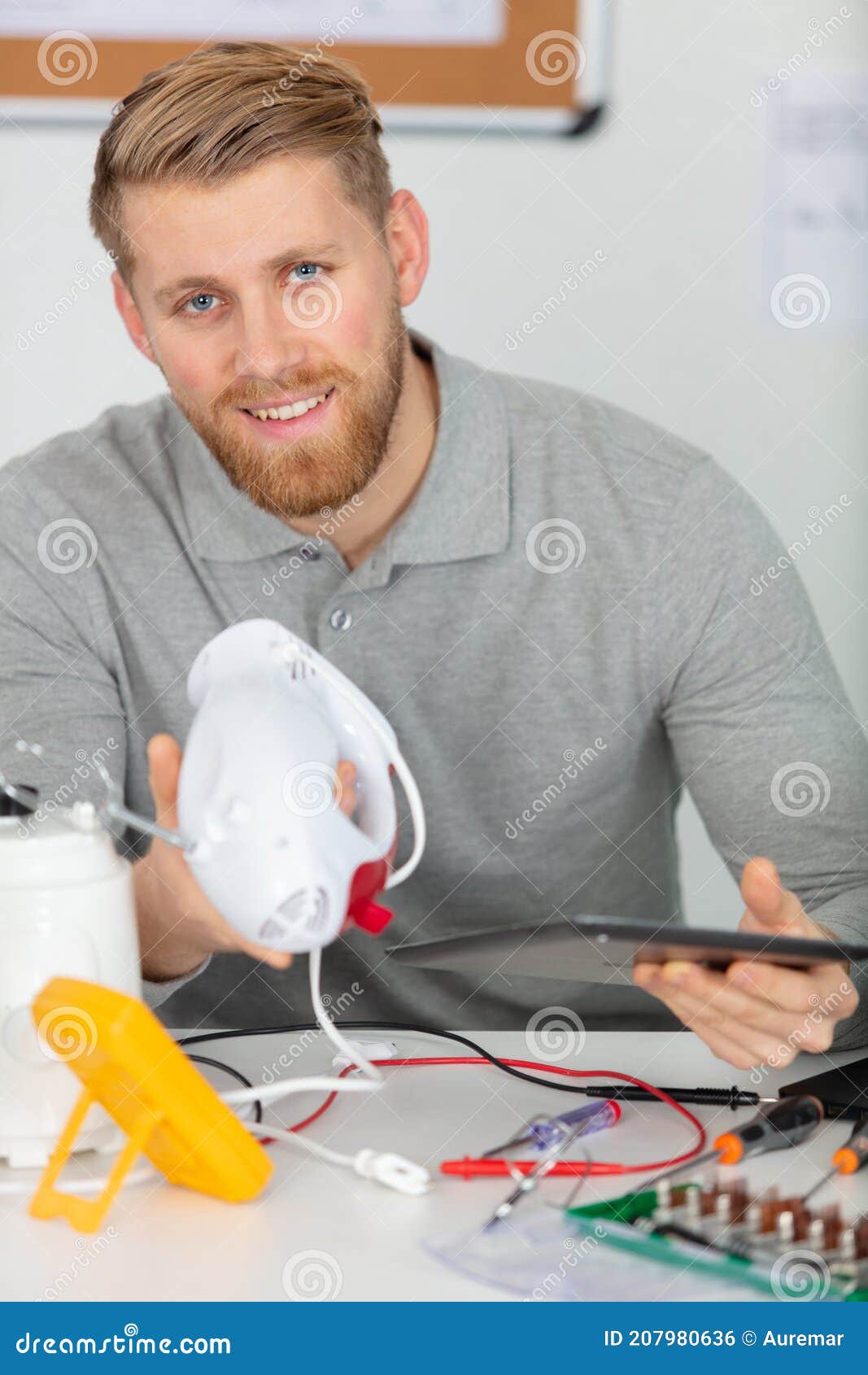 Young Energetic Male Tech or Engineer Repairs Electronic Equipment ...