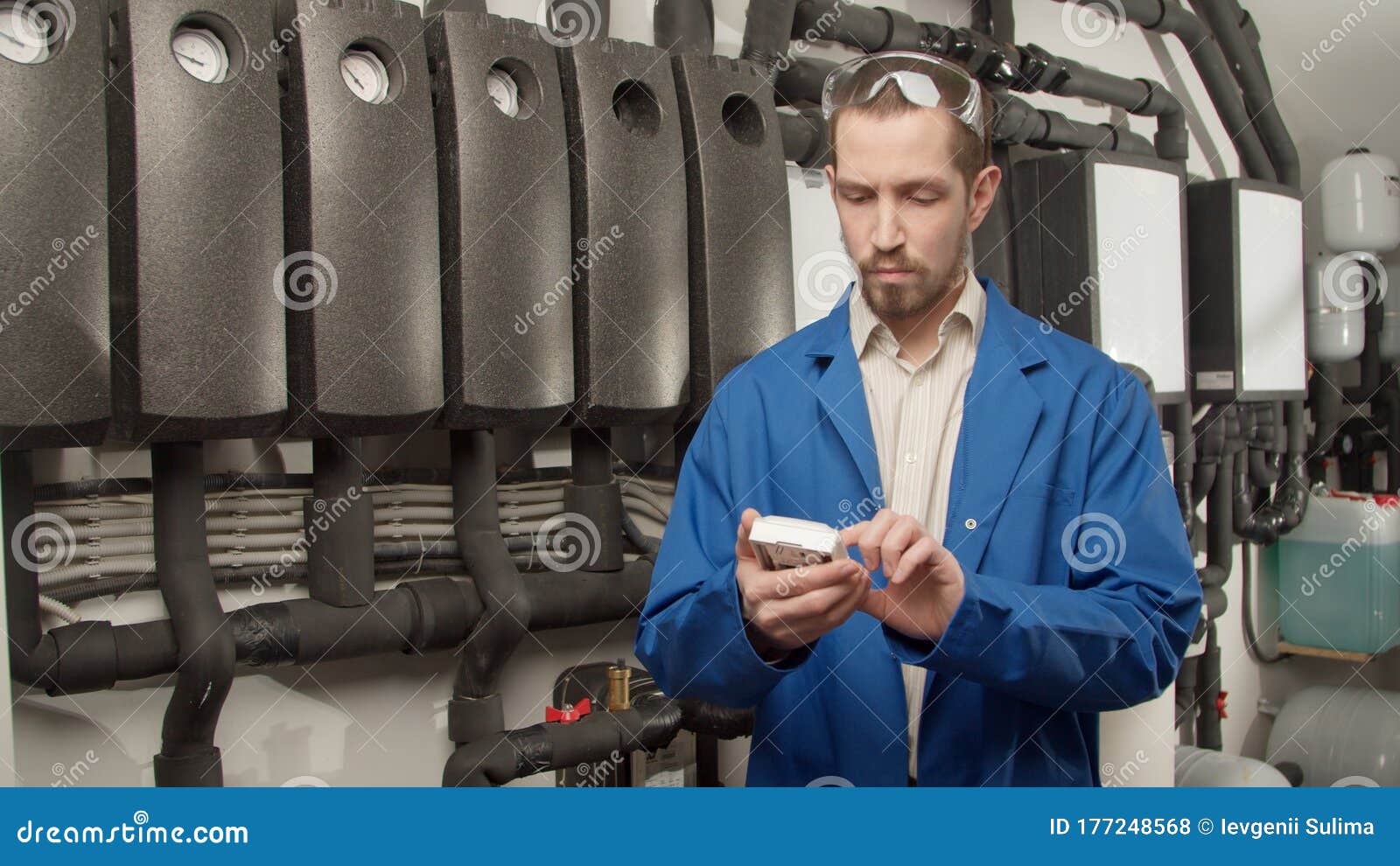 Young Engineer Checking New Equipment with Controller Stock Photo ...
