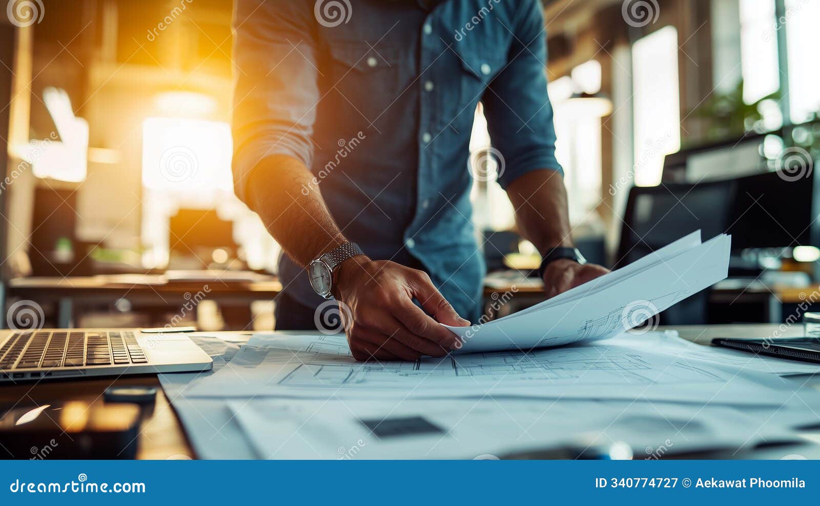 Professional Young Engineer Studying Building Plans for a Complex ...