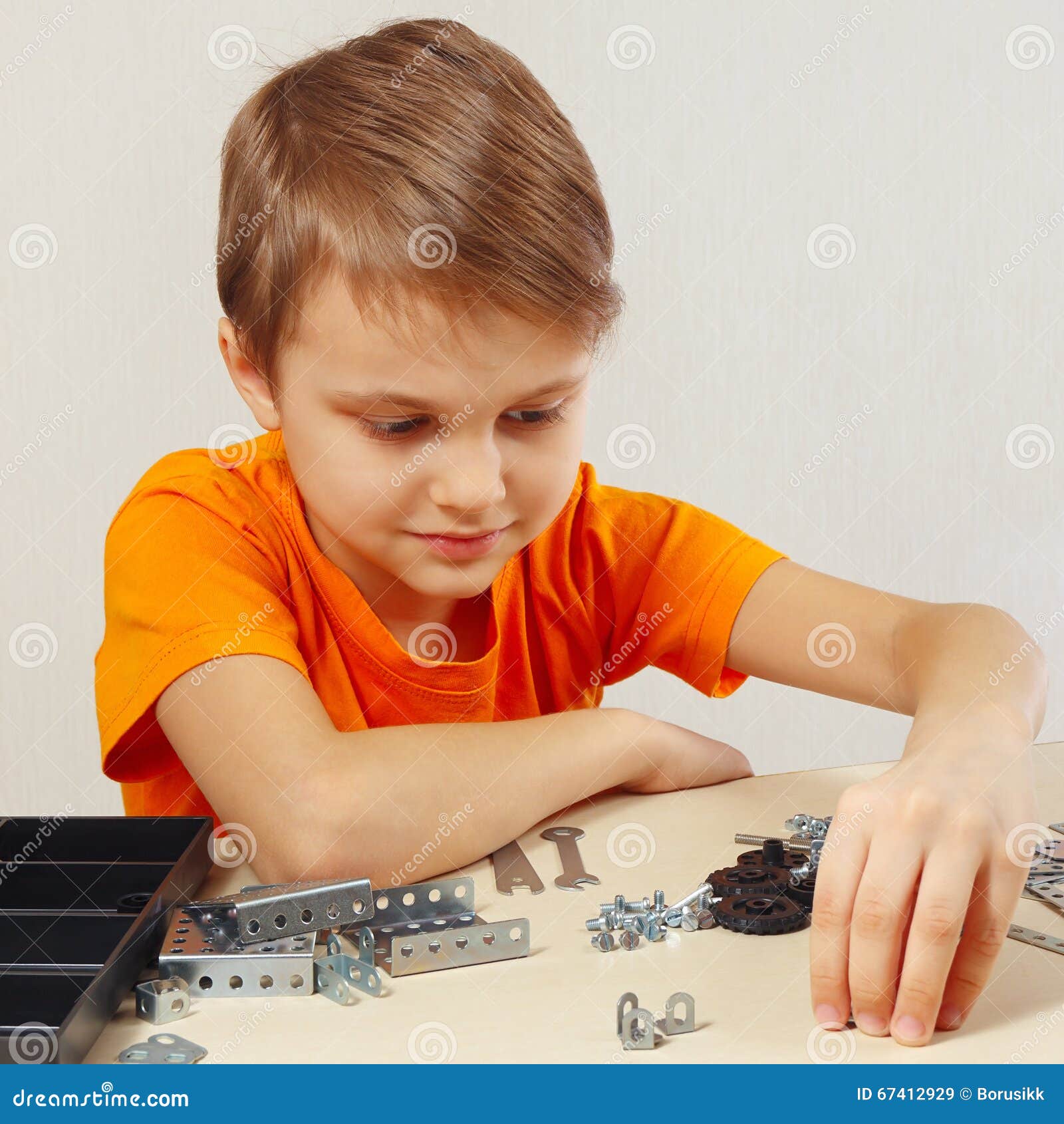 Young Engineer is Going To Play with Metal Constructor at the Table ...