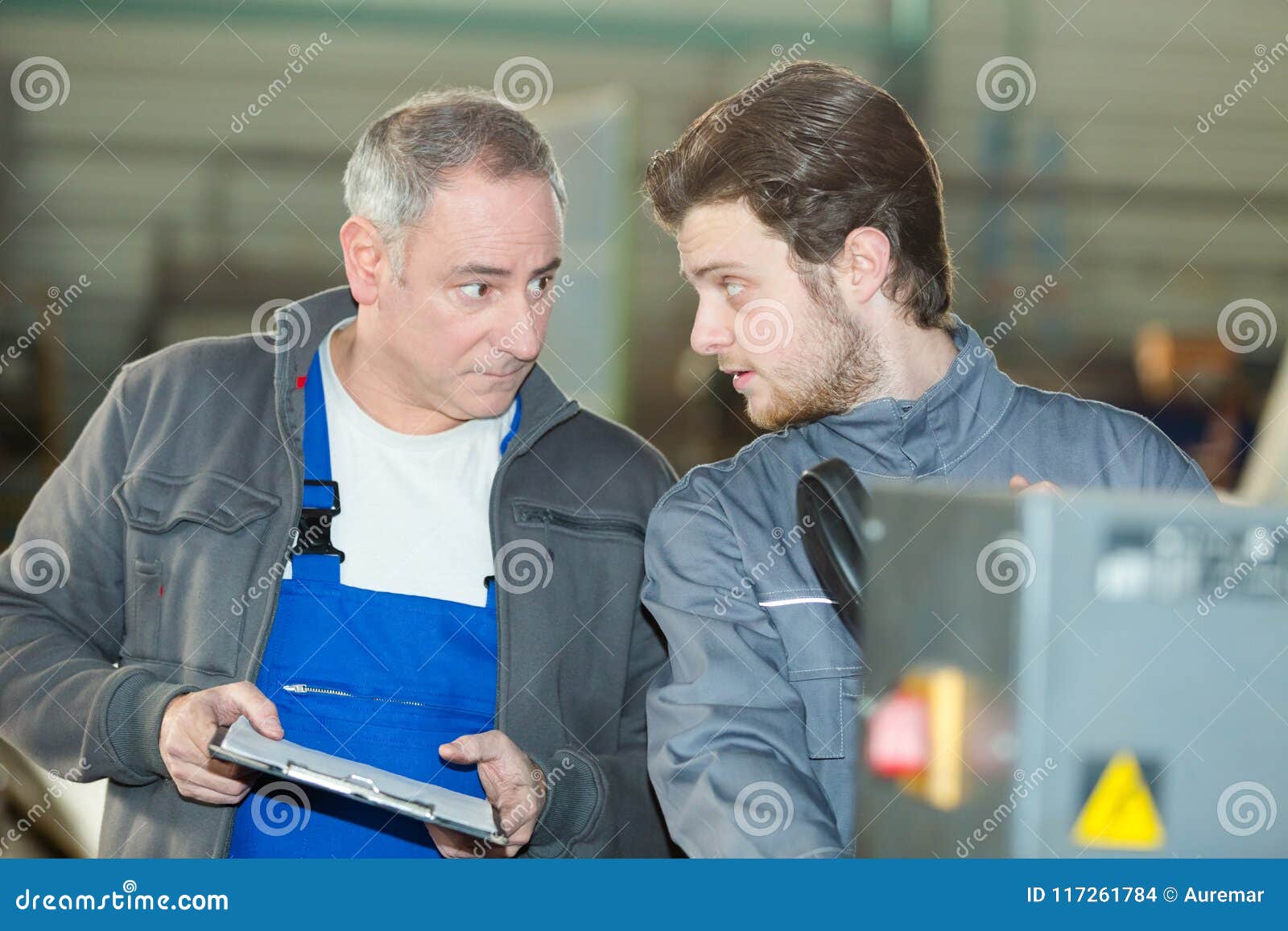 Young Engineer Having Discussion with Mentor in Factory Stock Photo ...