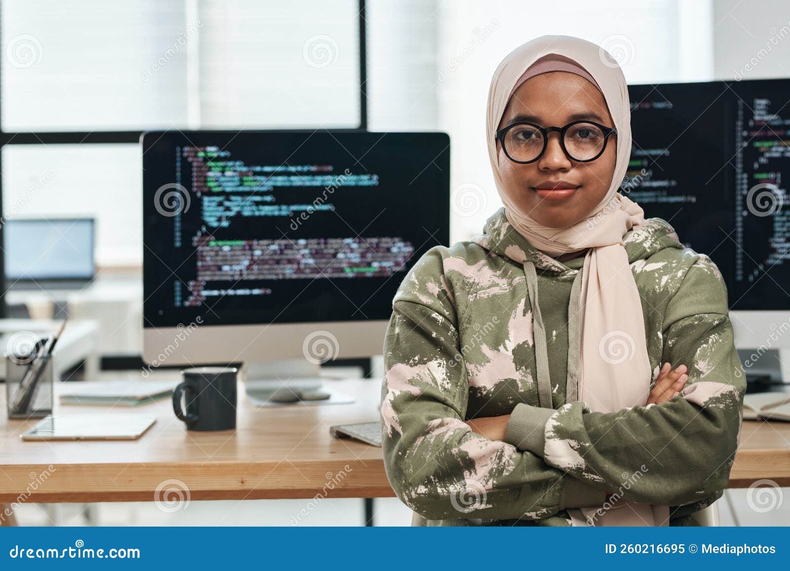 Young it Engineer in Hijab Sitting Against Computer Screens with Coded ...