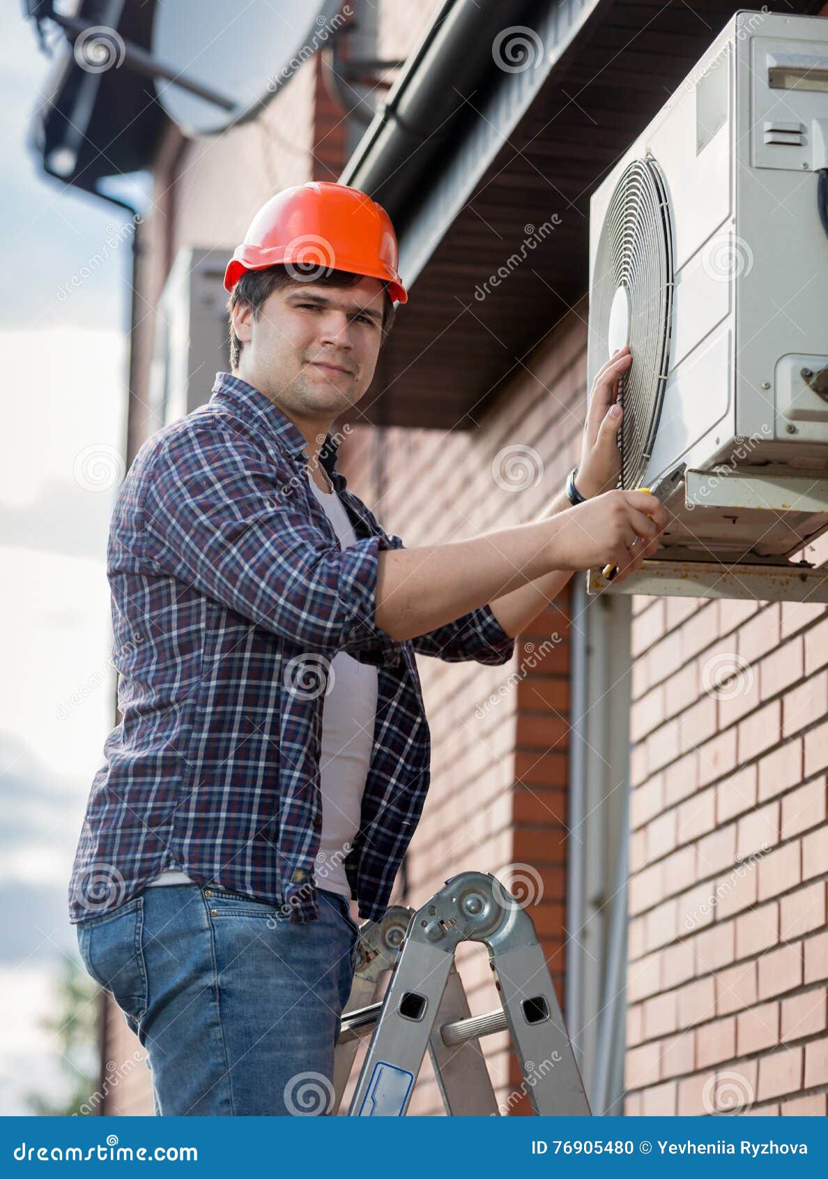 Young Engineer Installing Air Conditioner on Building Outer Wall Stock ...