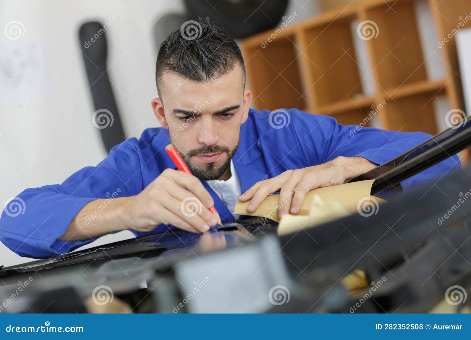 Young Engineer Marking Position with Pencil Stock Photo - Image of ...