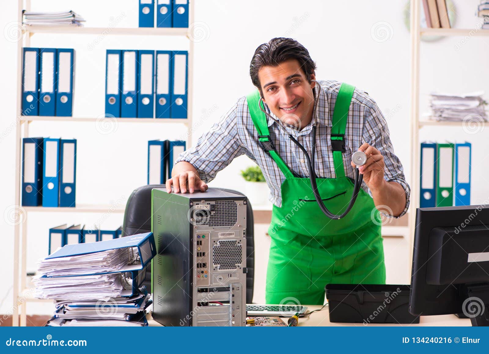 The Young Engineer Repairing Broken Computer at the Office Stock Photo ...