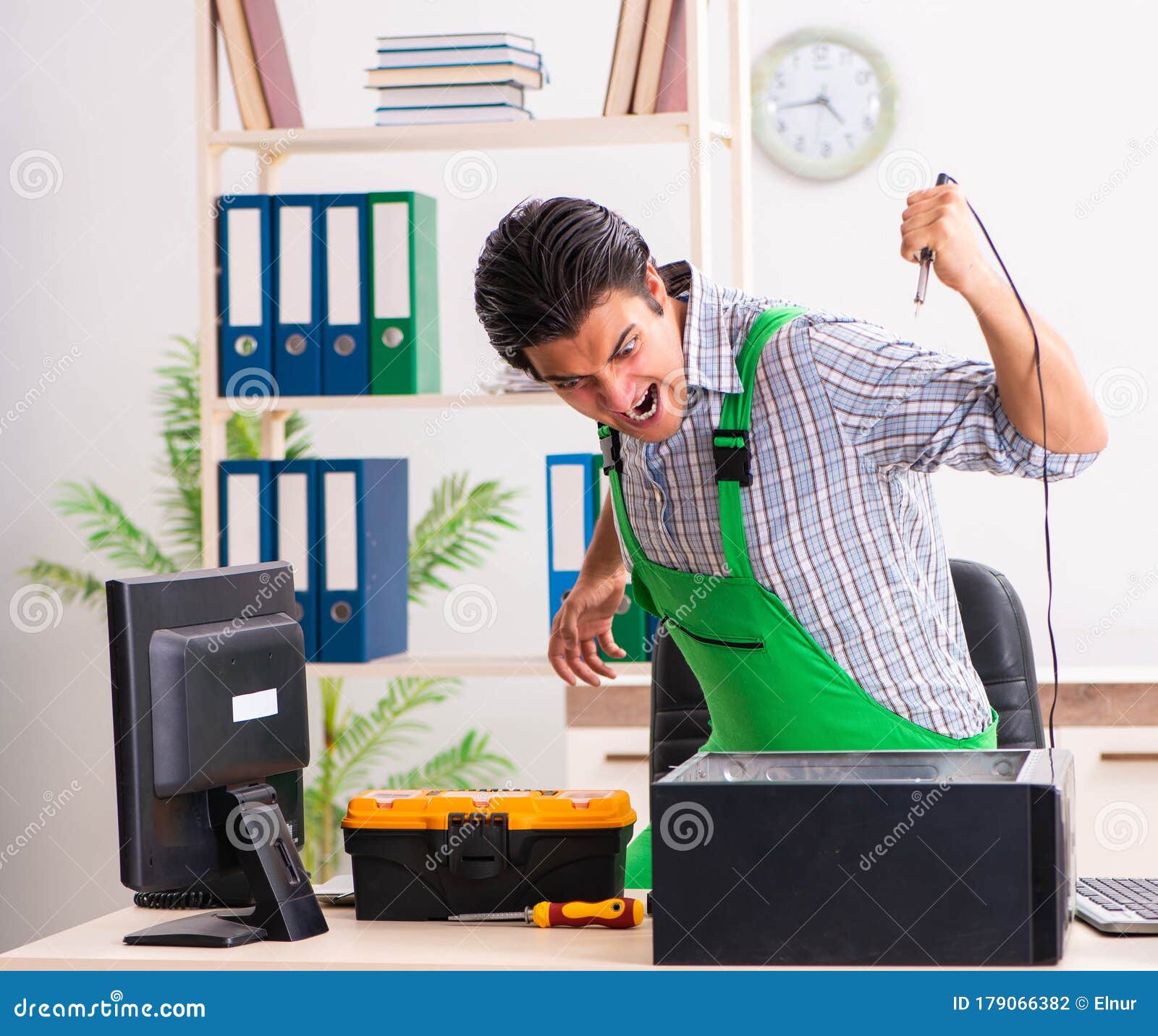 Young Engineer Repairing Broken Computer at the Office Stock Photo ...