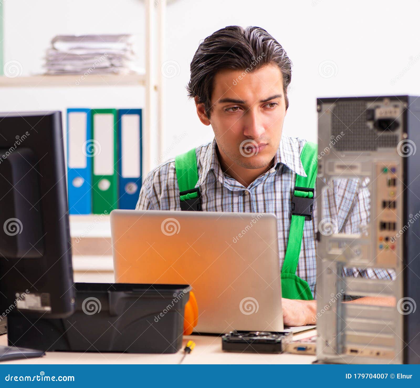 Young Engineer Repairing Broken Computer at the Office Stock Image ...