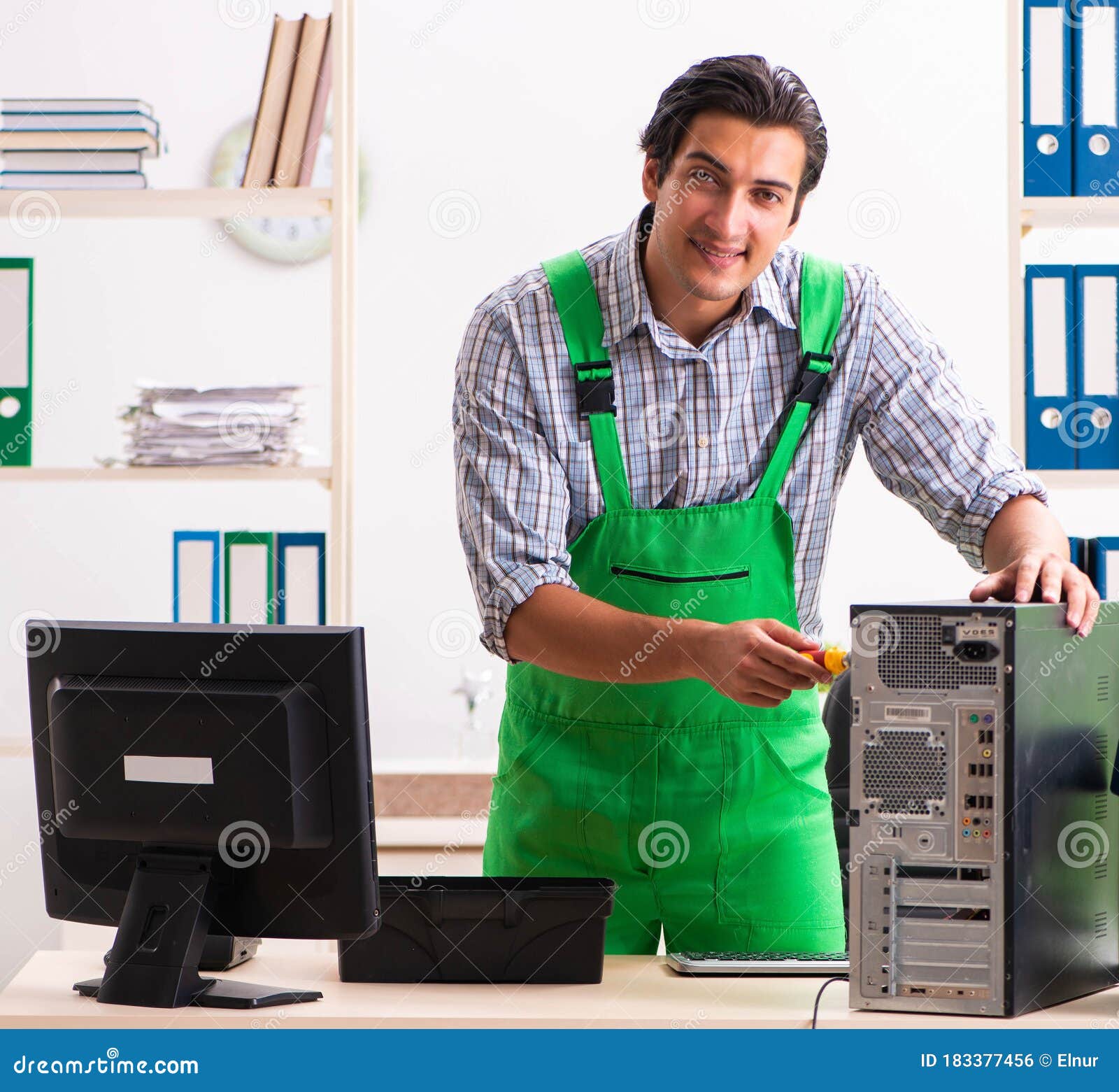 Young Engineer Repairing Broken Computer at the Office Stock Photo ...