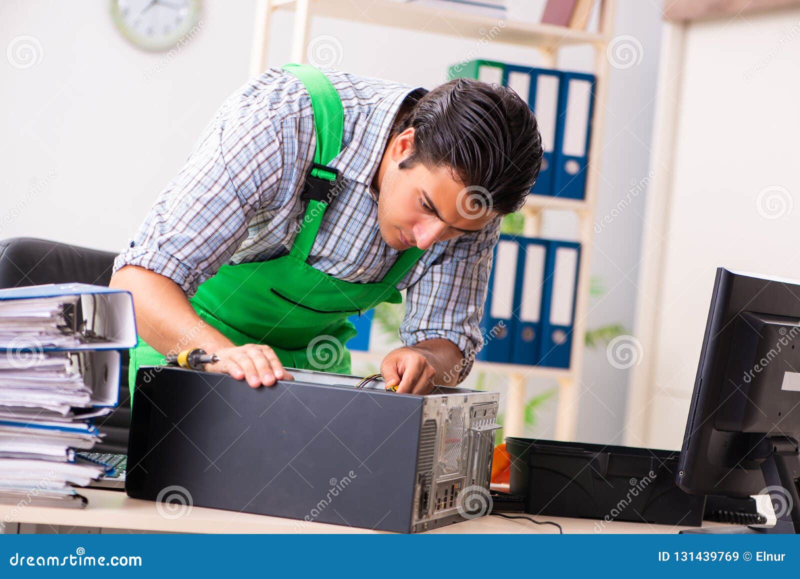 The Young Engineer Repairing Broken Computer at the Office Stock Image ...