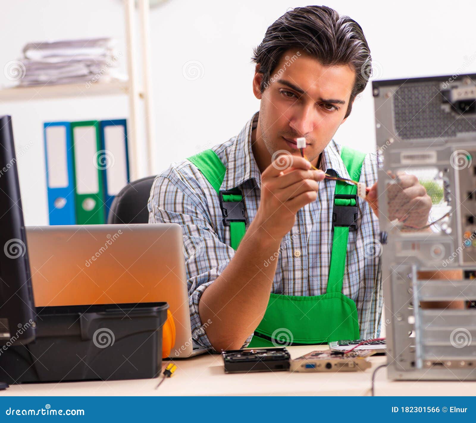 Young Engineer Repairing Broken Computer at the Office Stock Photo ...