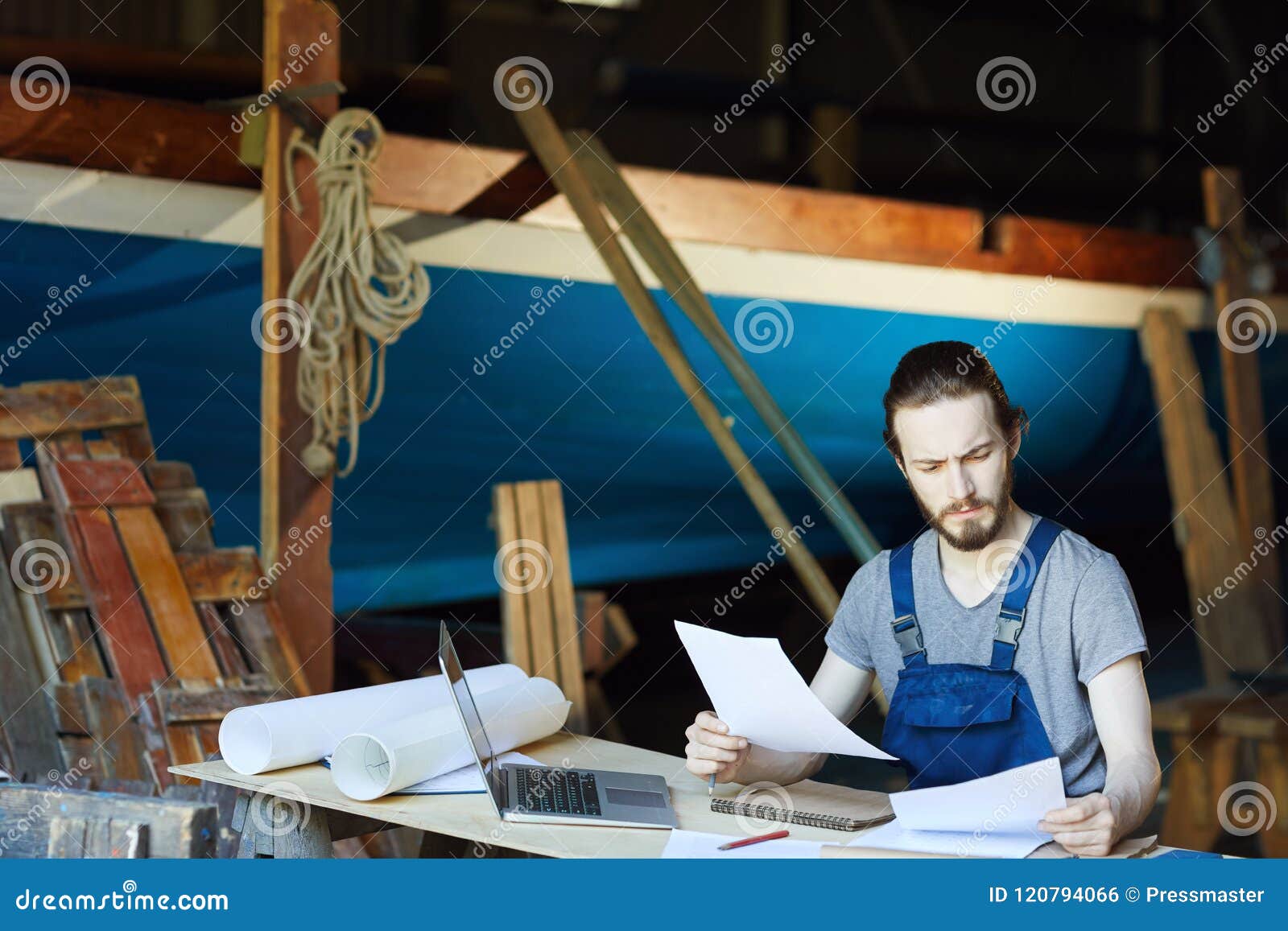 Engineer with papers stock photo. Image of laptop, hangar - 120794066