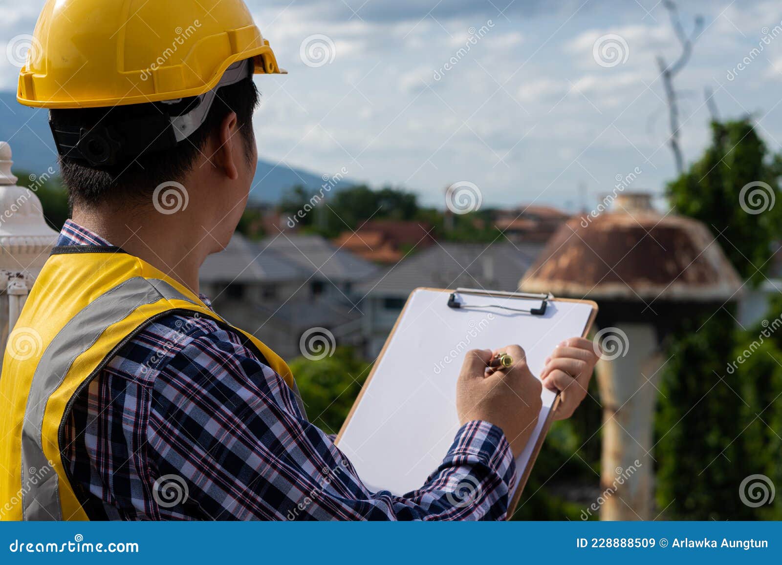 Back View of Young Engineer Recording Entries in Notebook Stock Image ...