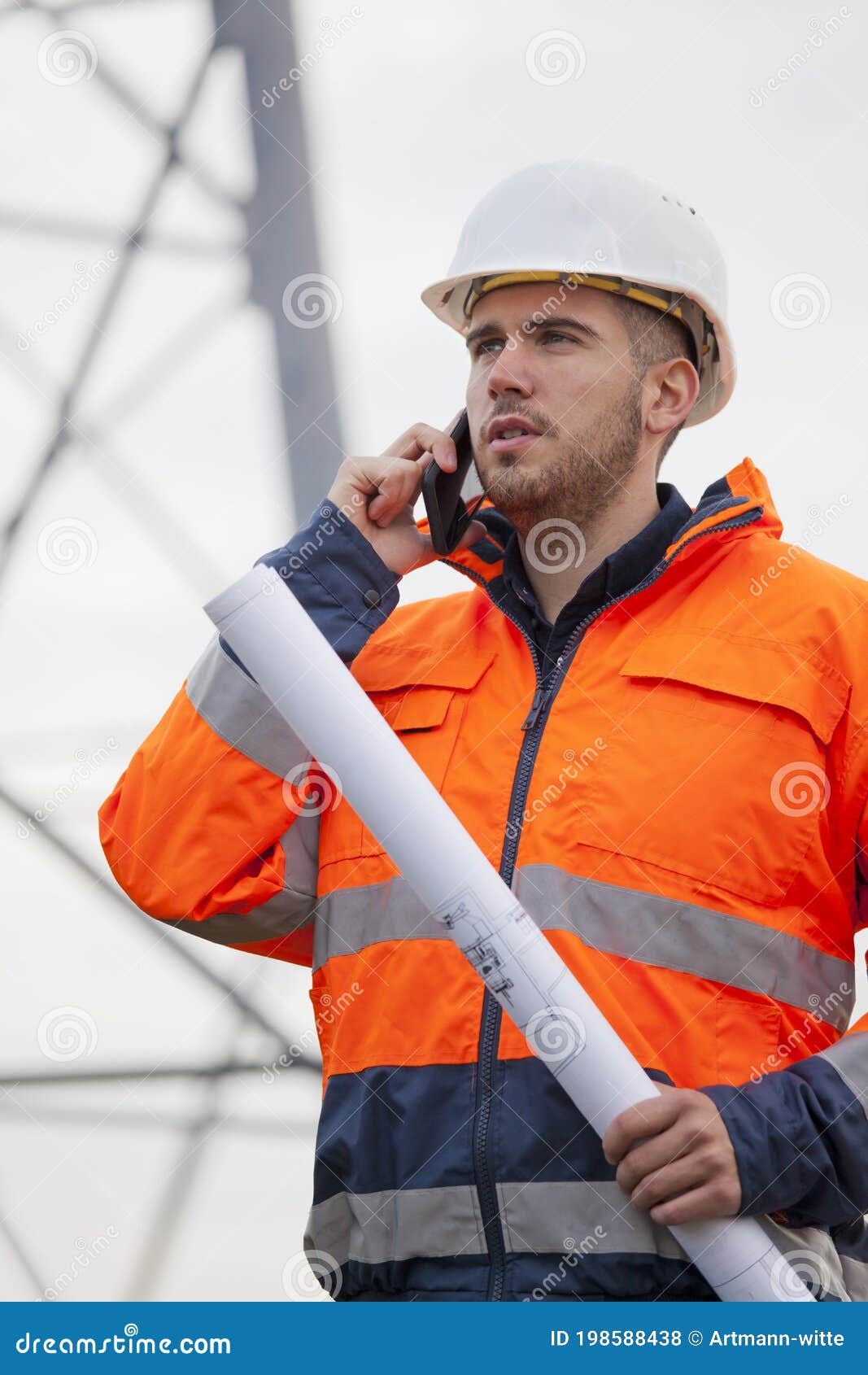 Young Engineer Talking on Smart Phone in Front of an Oil Rig or ...