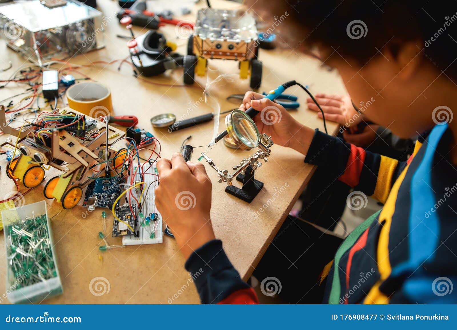Improvement. Close Up of Young Engineer Using Soldering Iron To Join ...