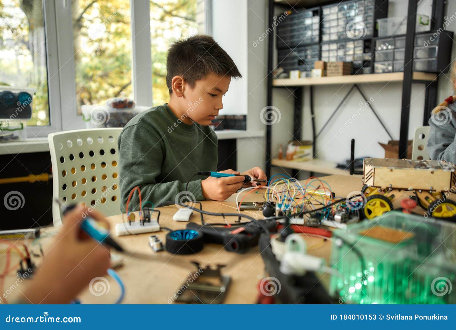 Passion That Builds Excellence. Young Engineer Using Soldering Iron To ...