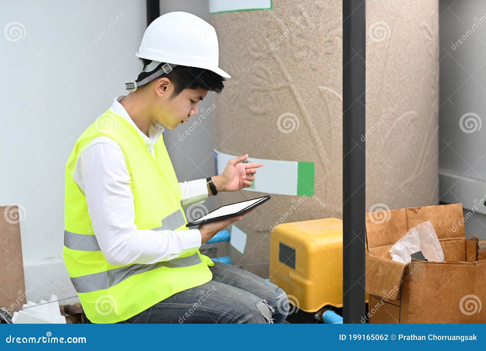 Young Engineer Using Tablet while Sitting at Construction Site. Stock ...
