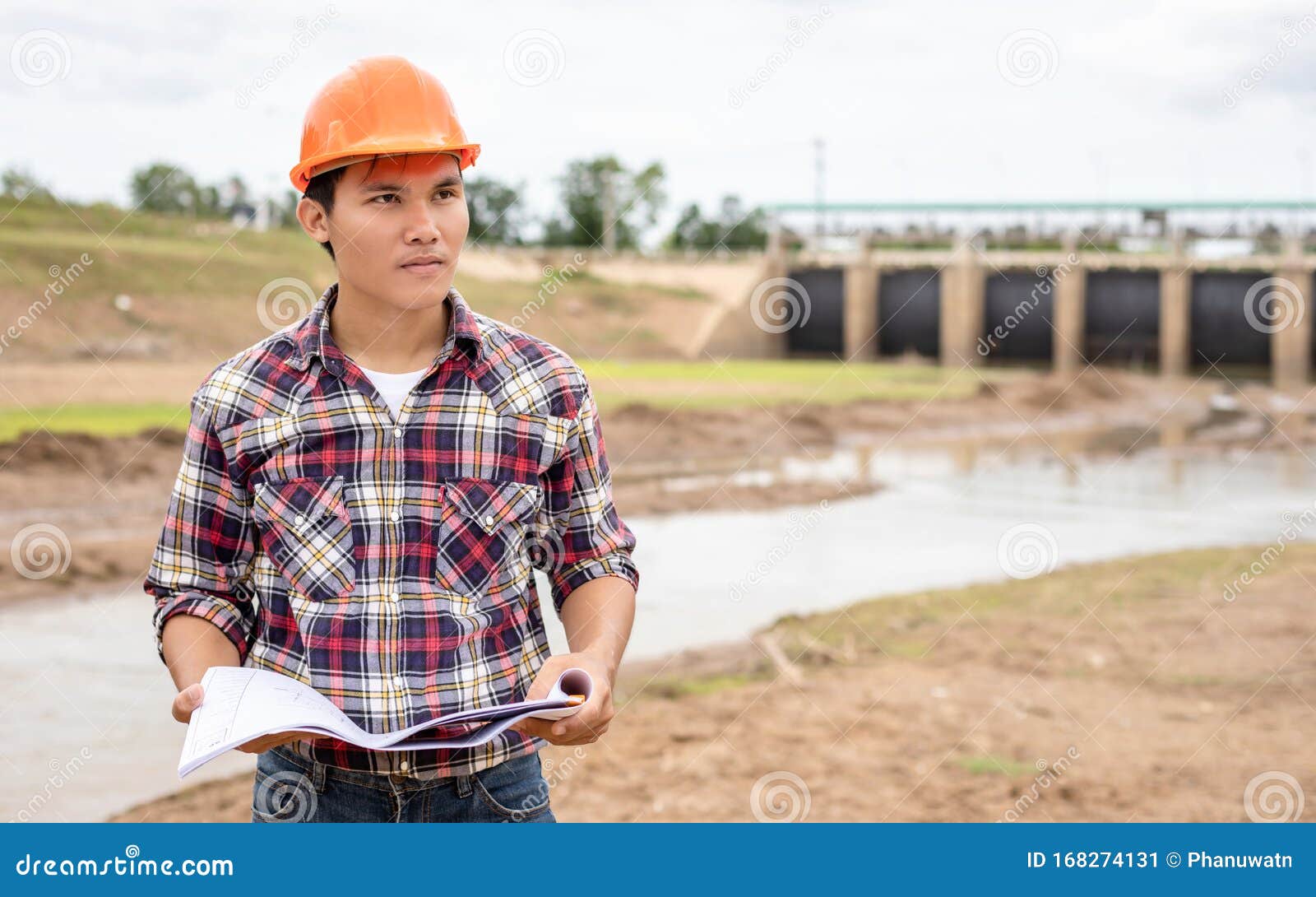 Young Engineer Working on Site at the Dam Stock Image - Image of ... Young Engineer Working on Site at the Dam Stock Image - Image of ...