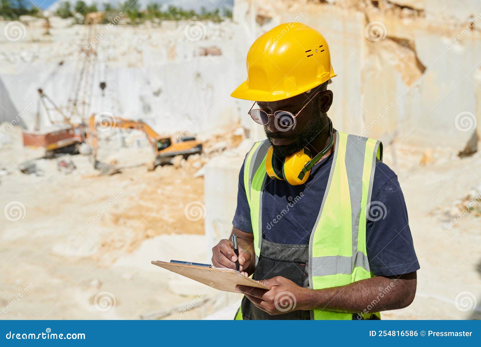 Young Engineer in Workwear Making Notes in Working Document in ...