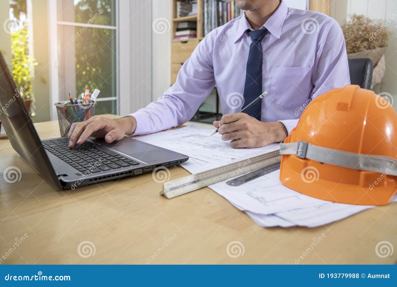 Young Engineers Holding a Pencil Pointing To a Building on a Blueprint ...