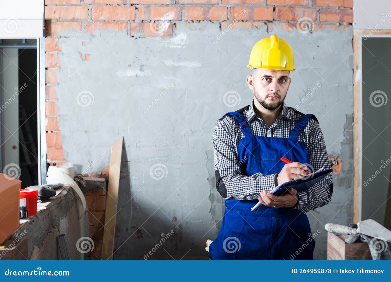 Worker is Writing Report about Work for Client at the Object. Stock ...