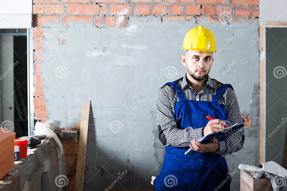 Worker is Writing Report about Work for Client at the Object. Stock ...