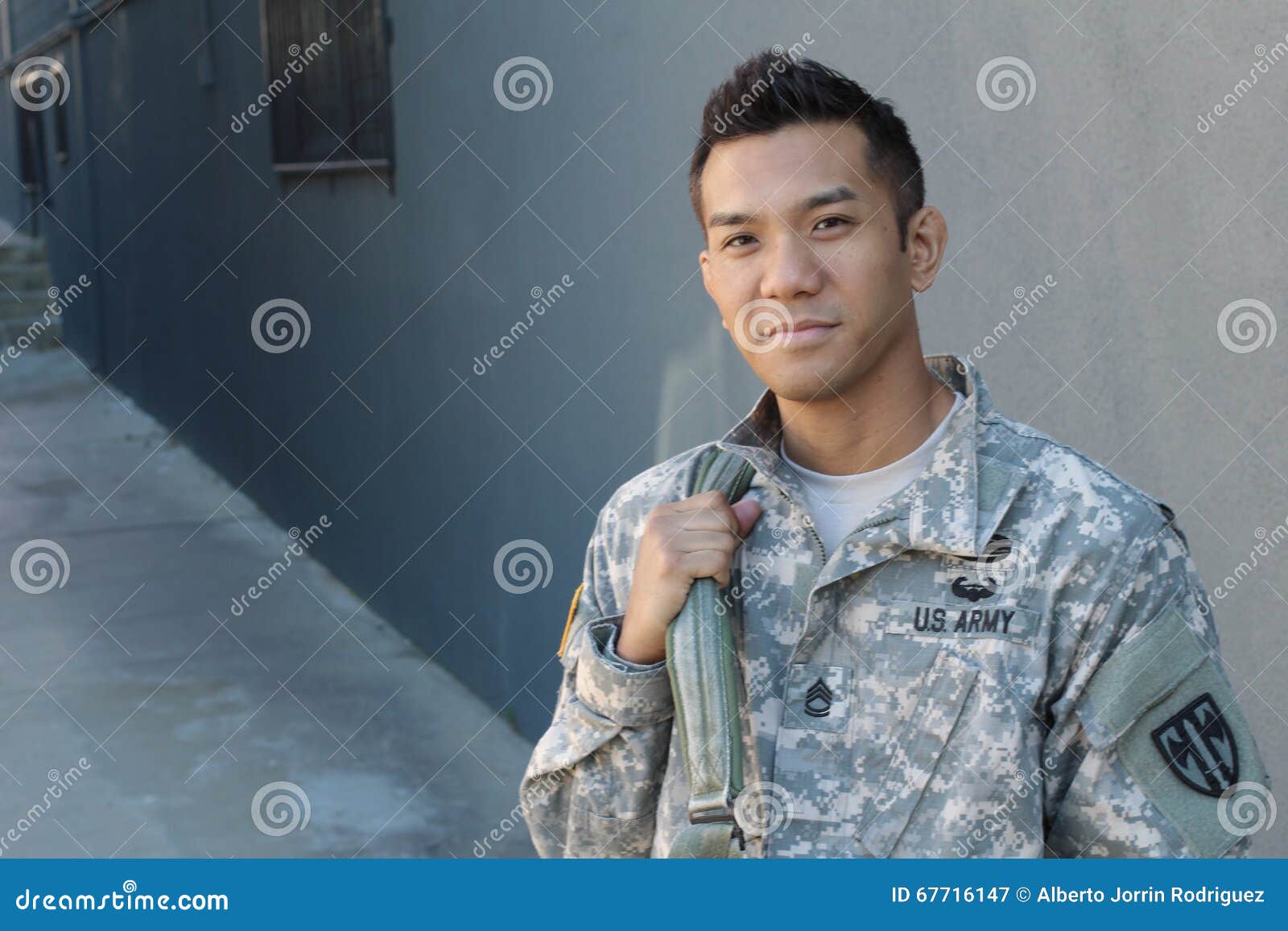 Young Ethnically Ambiguous American Soldier Holding Backpack Stock ...