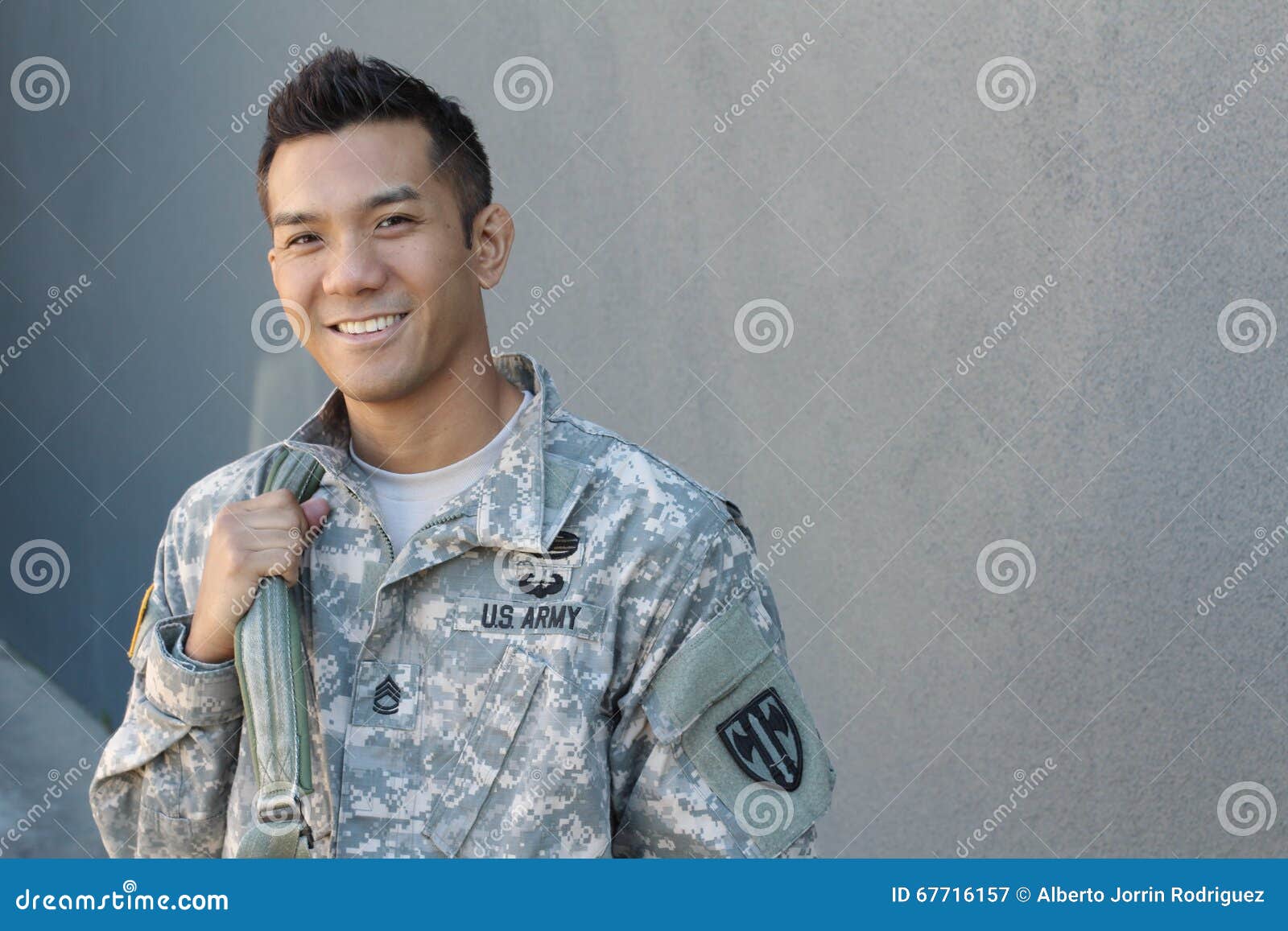 Young Ethnically Ambiguous American Soldier Holding Backpack Stock ...
