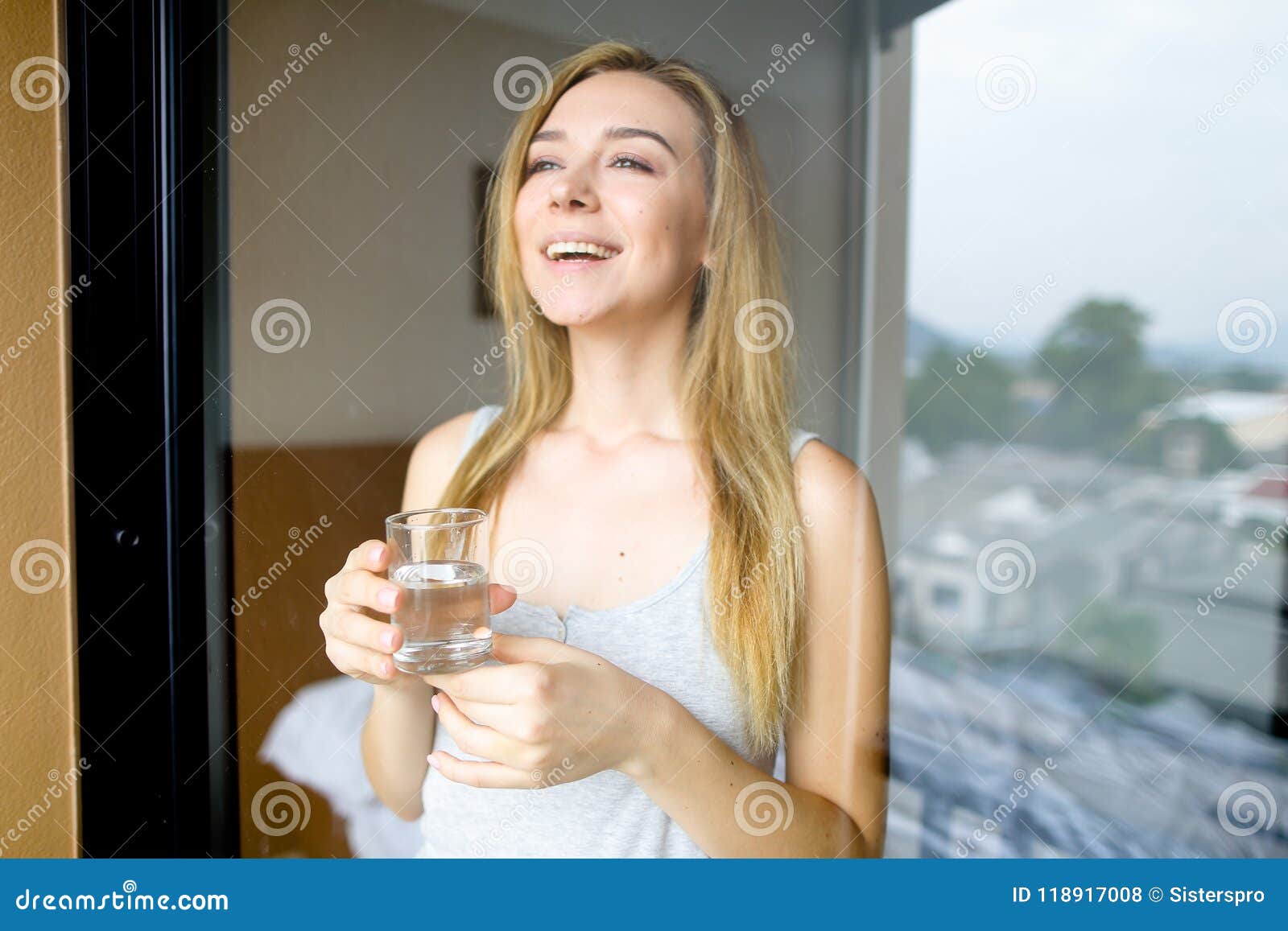 Young European Female Person Drinking Glass Of Water In Morning At