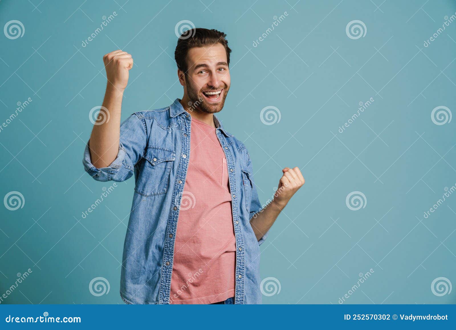 Young Excited Man Screaming while Making Winner Gesture Stock Photo ...