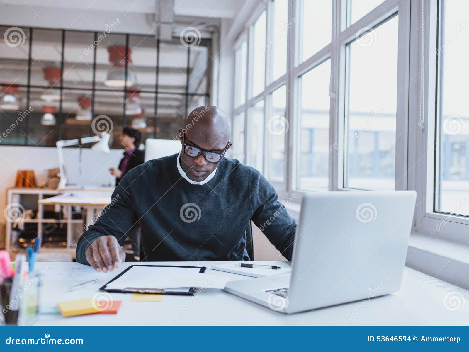 Young Executive at His Desk Reading a Document Stock Photo - Image of ...
