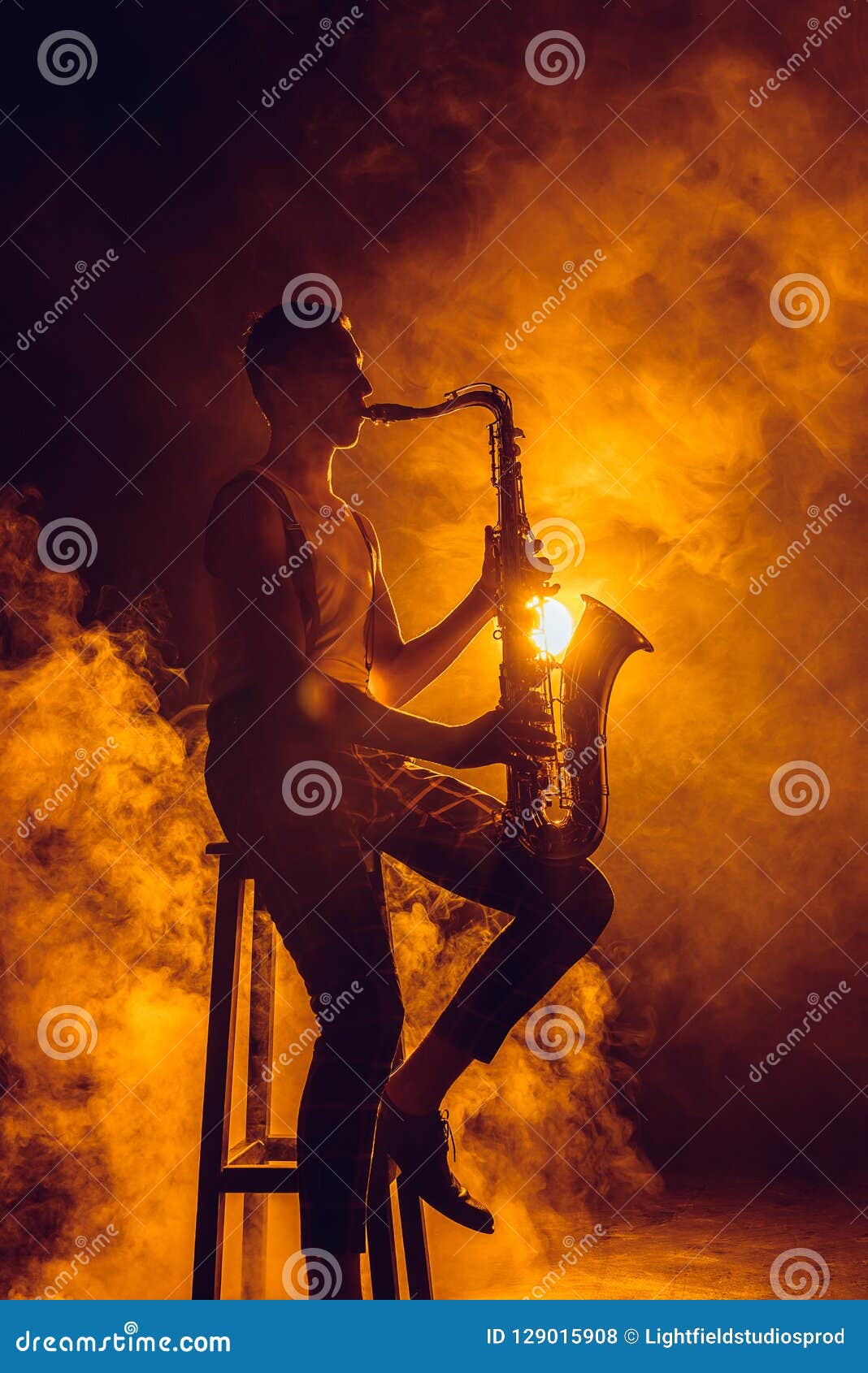 Young Expressive Jazzman Sitting on Stool Stock Photo - Image of ...