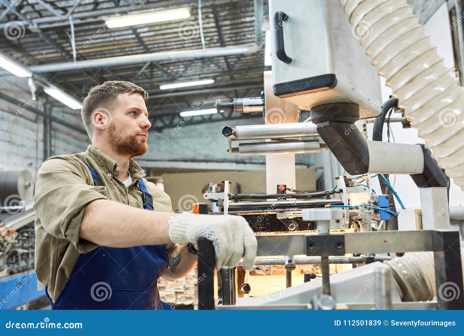 Young Factory Workers Operating Machine Stock Image - Image of ...