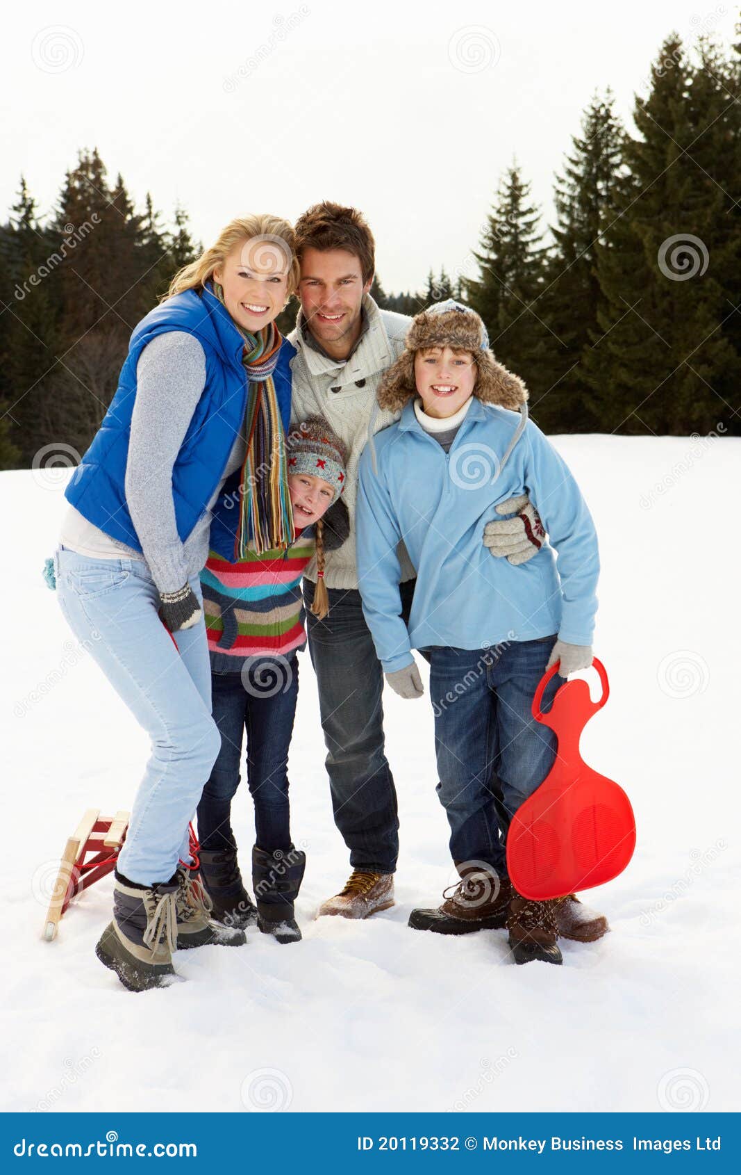 Young Family in Alpine Snow Scene with Sleds Stock Photo - Image of ...