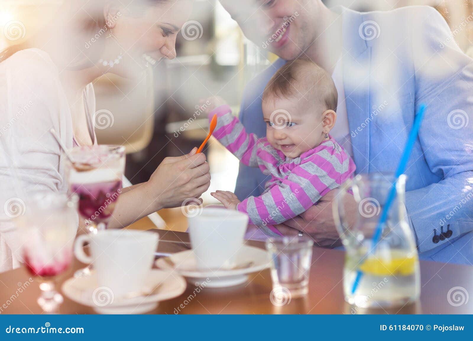 Young family in cafe stock photo. Image of arms, casual - 61184070