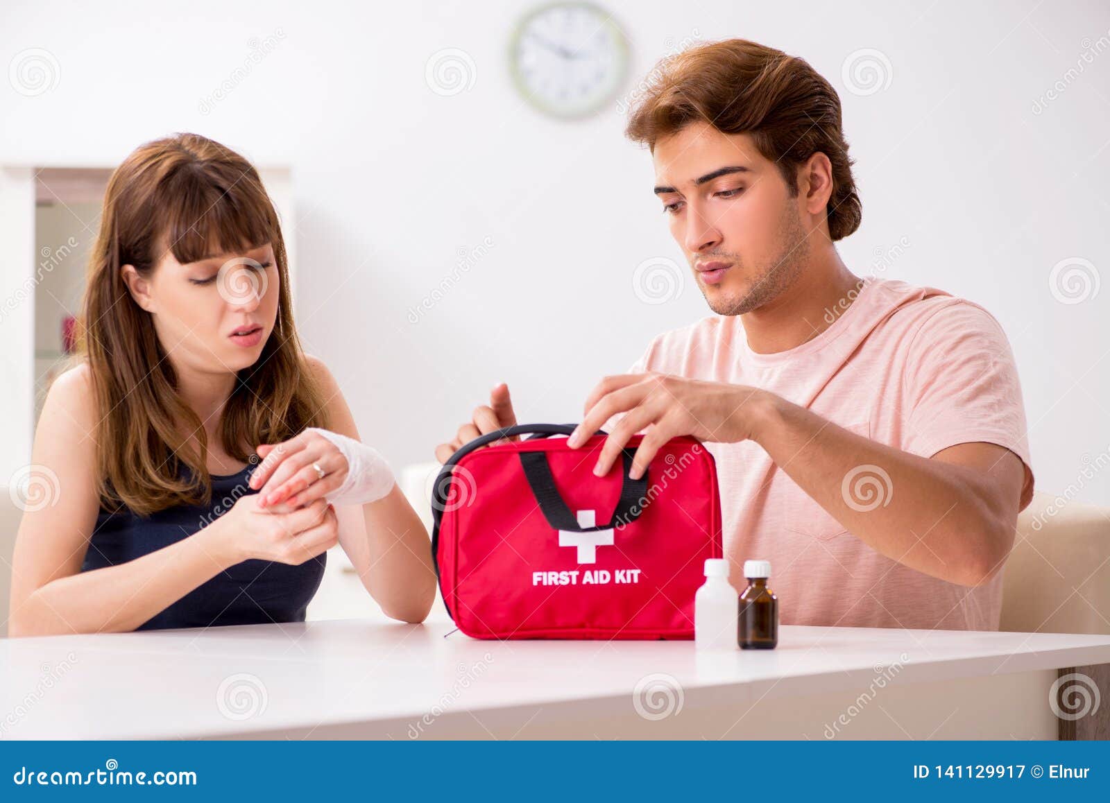 The Young Family Getting Treatment with First Aid Kit Stock Image ...