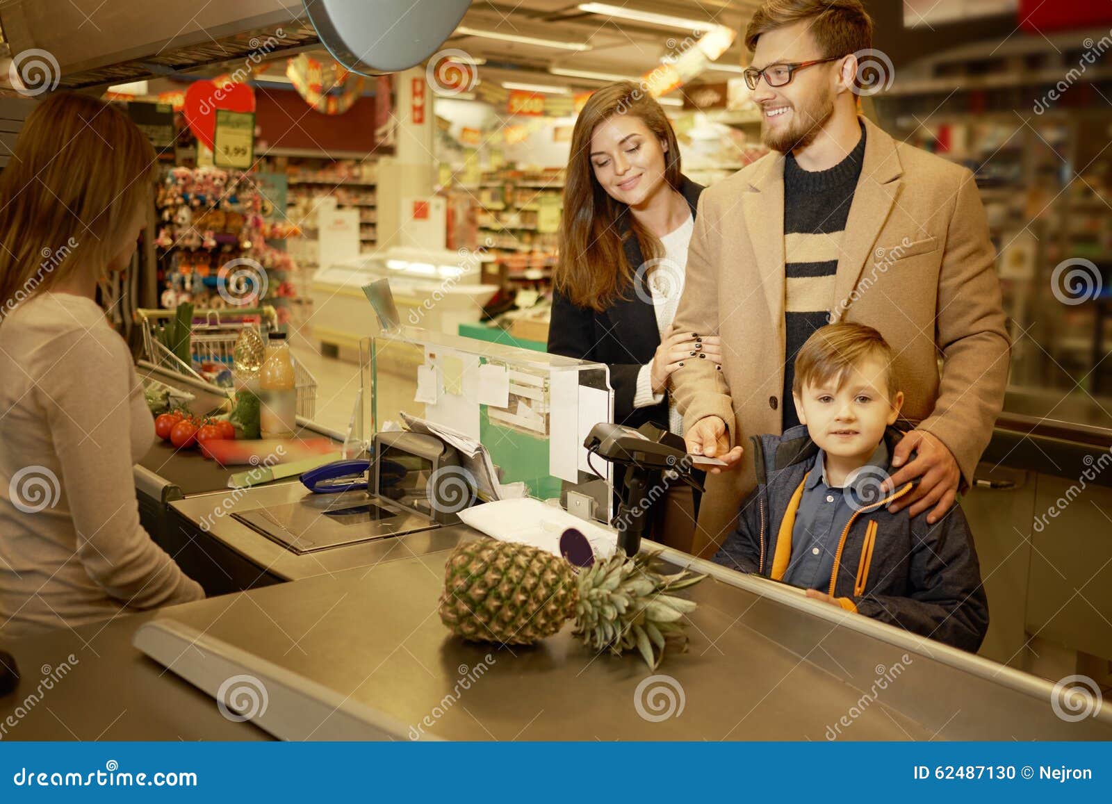 Young Family in a Grocery Store Stock Photo - Image of cashier ...